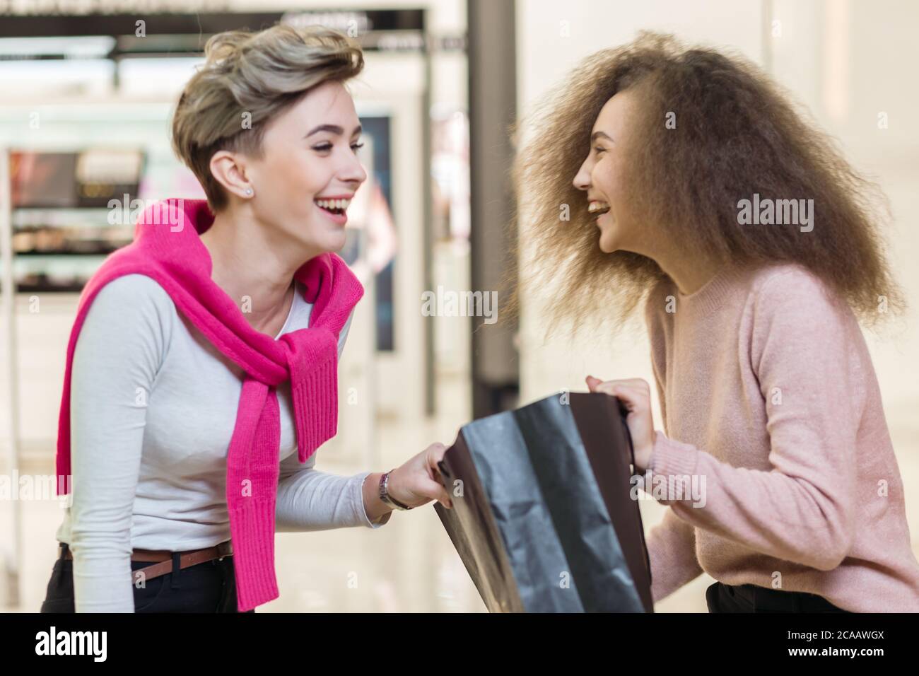 Women talking to shop assistant hi-res stock photography and images - Alamy
