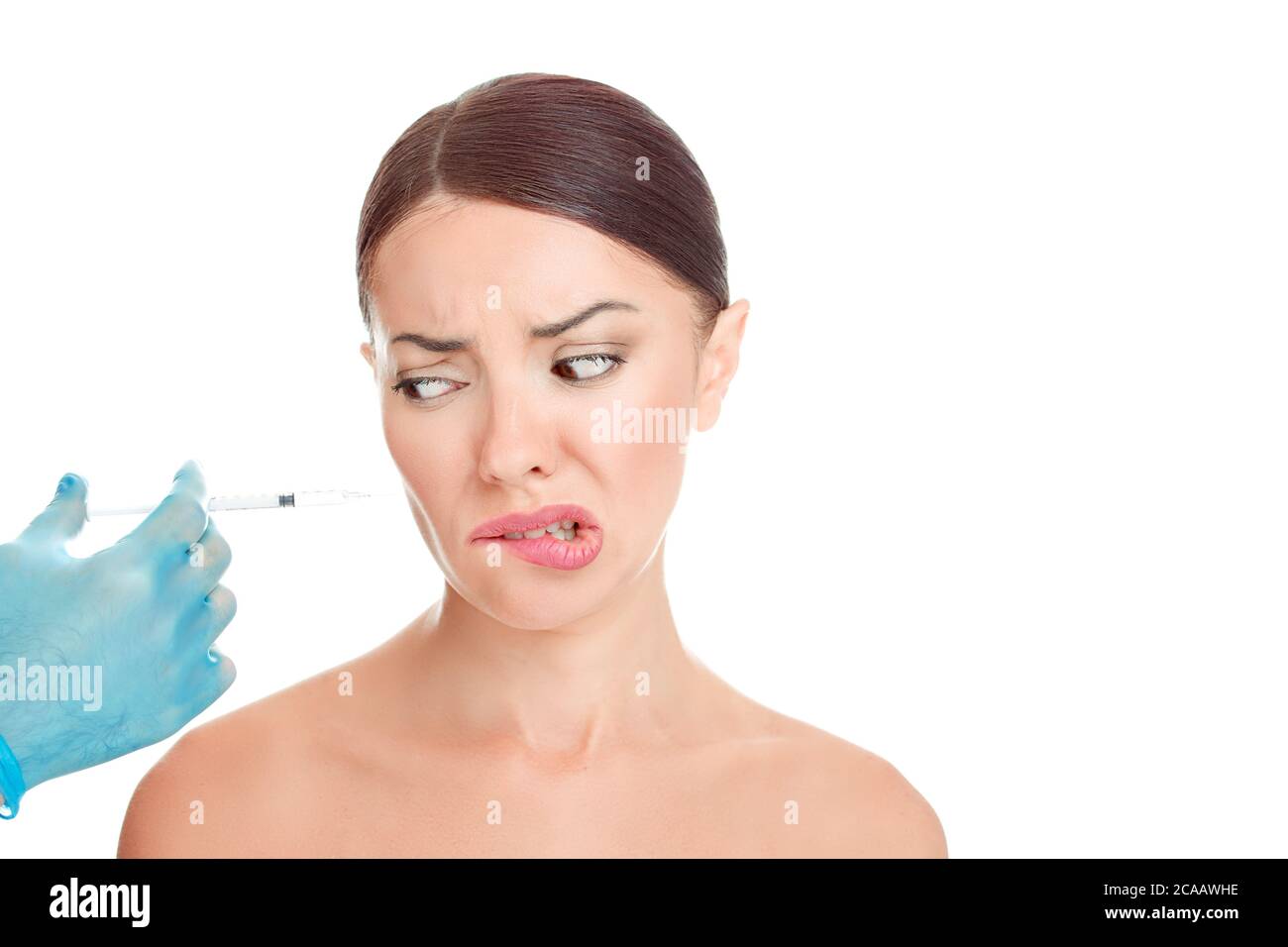 Woman looks to the syringe, is afraid of doctor, syringe, aesthetic ...