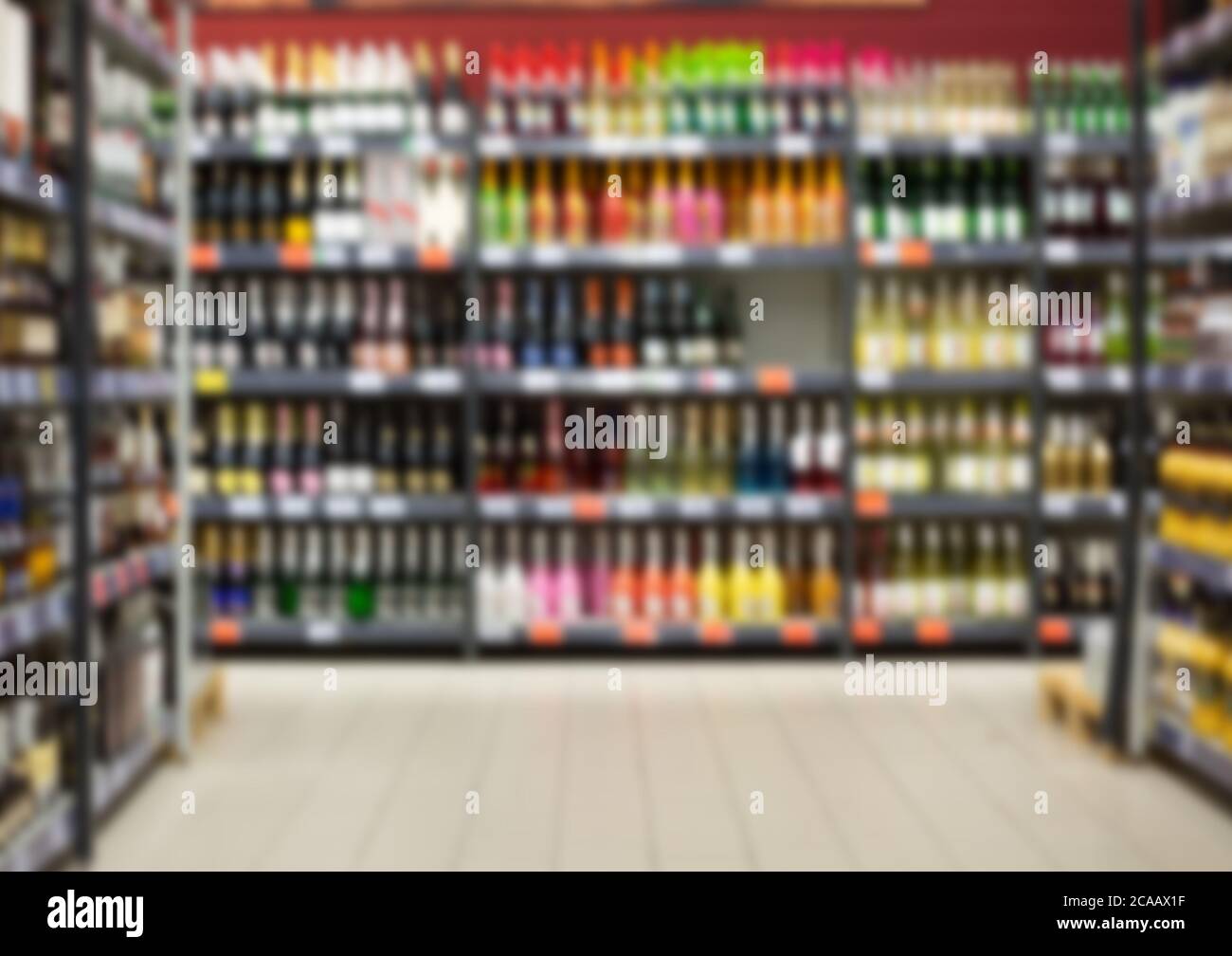Blurred bottles on the shelves in the supermarket Stock Photo - Alamy