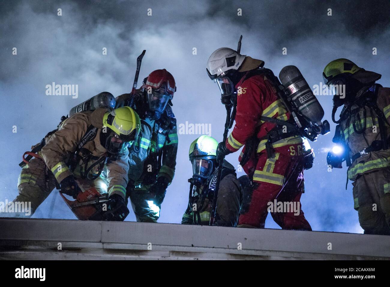 Firefighters battle house fire on roof Stock Photo - Alamy