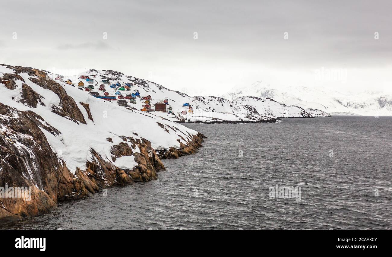 Greenlandic fjord rocky shores landscape with settlement on the hill in ...