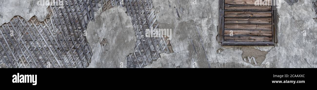 Old wooden walls with plaster crossed base with window covered with ...