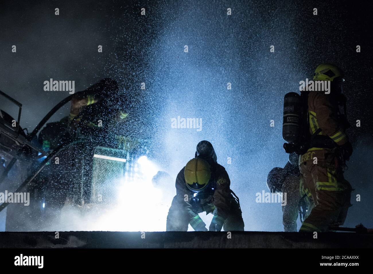 Firefighter using hose hi-res stock photography and images - Alamy