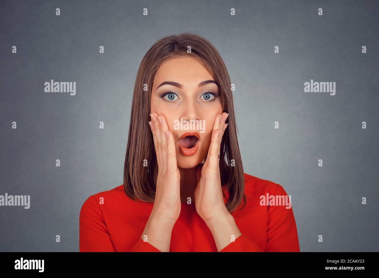 Shocked surprised stunned. Closeup portrait happy young woman in red ...