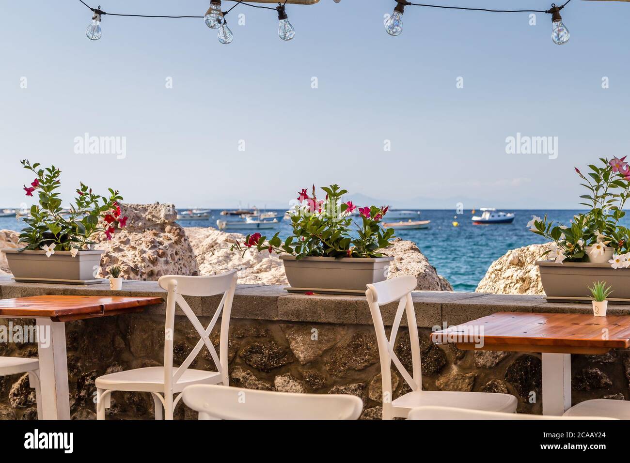 Restaurant tables overlooking mediterranean sea hi-res stock ...