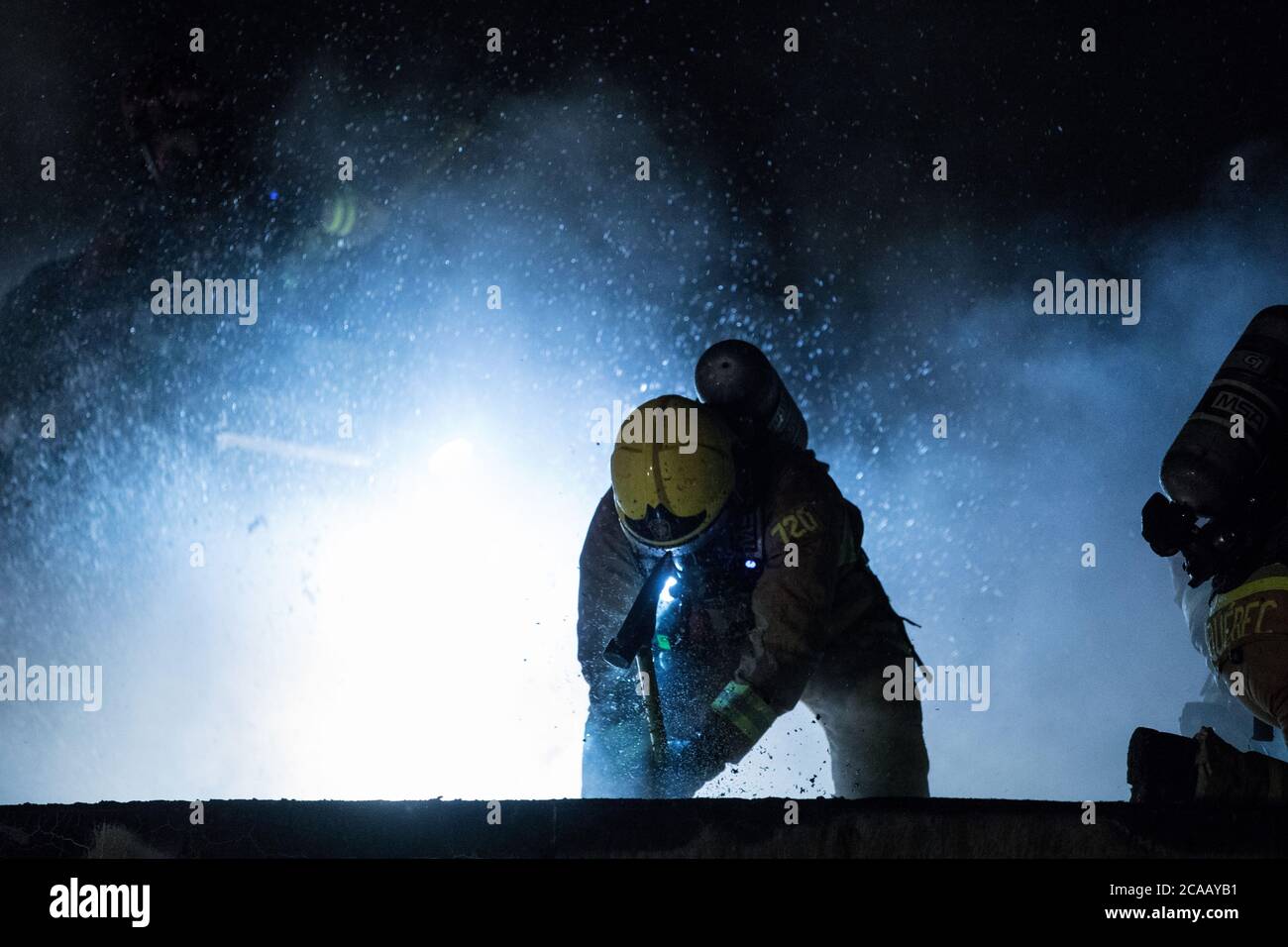Firefighter using axe on roof. Editorial Use only Stock Photo - Alamy