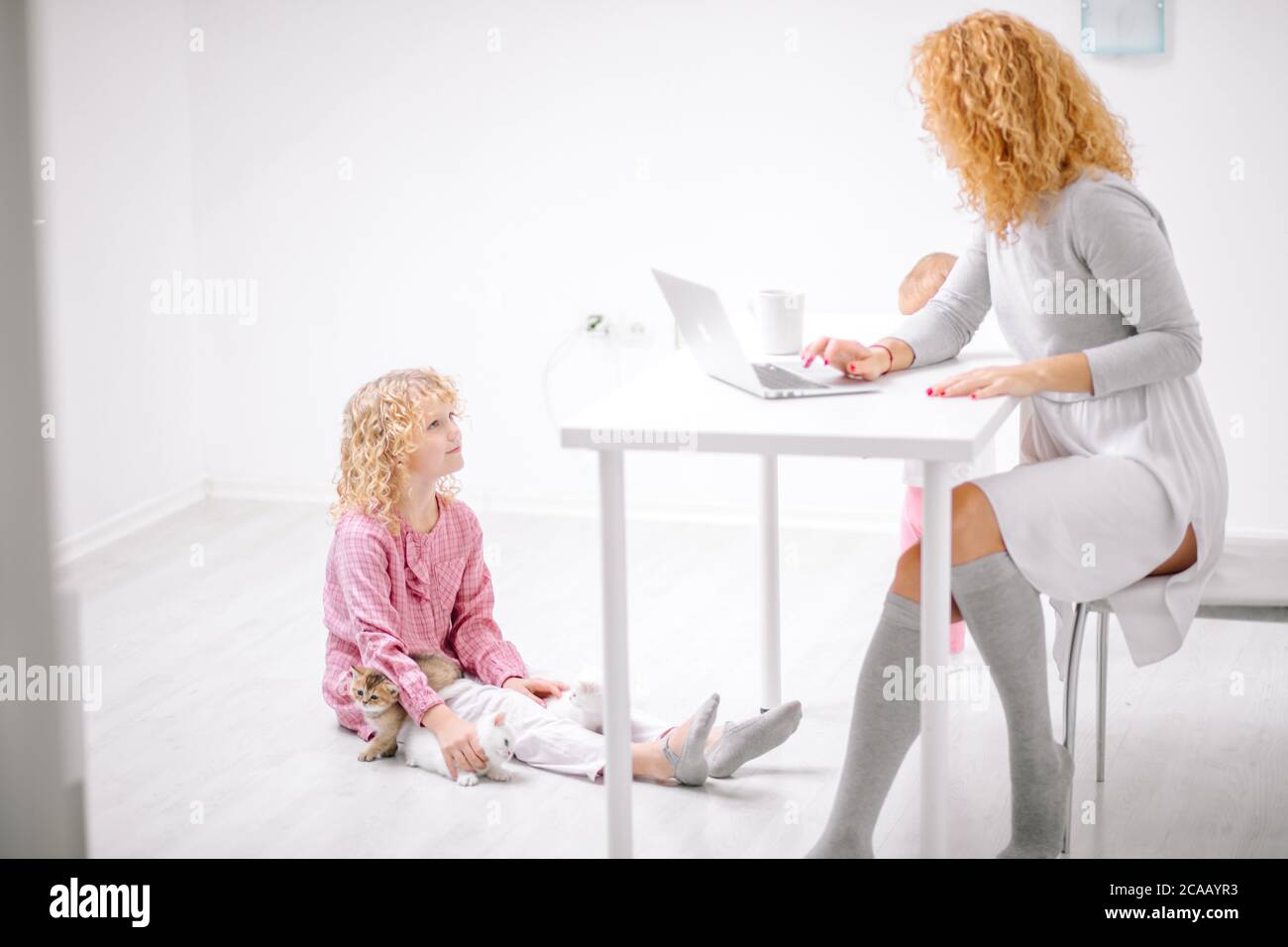 woman teaching the girl in friendly atmosphere. side view photo ...