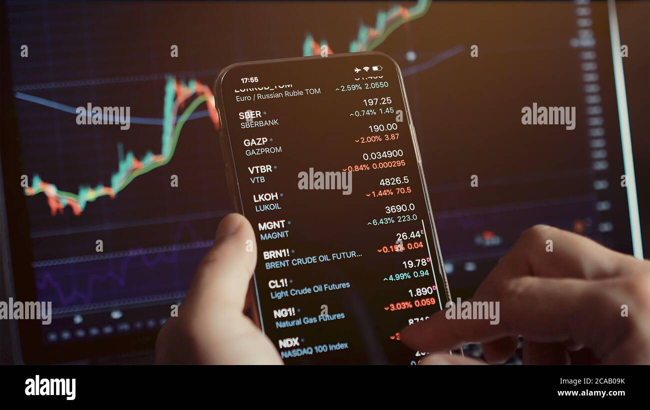 investment stockbroker risk analysis using multiple devices Stock Photo ...