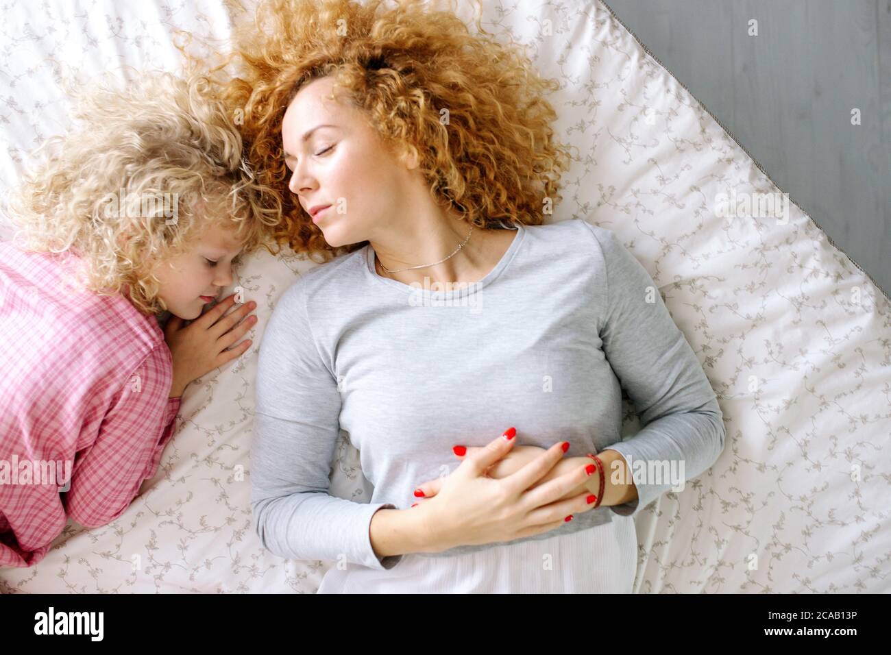 sleeping family on the bed. top view photo. free time, lifestyle ...