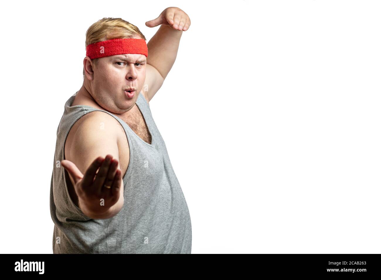 Feeling furious. Fat man in red ribbon handband screaming, threaten to ...