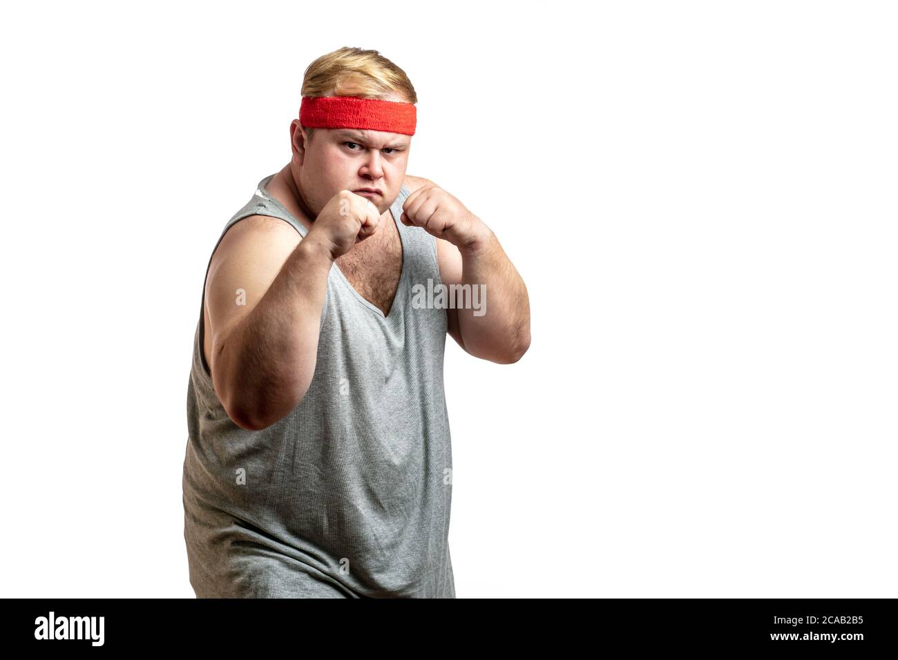 Feeling furious. Fat man in red ribbon handband screaming, threaten to ...