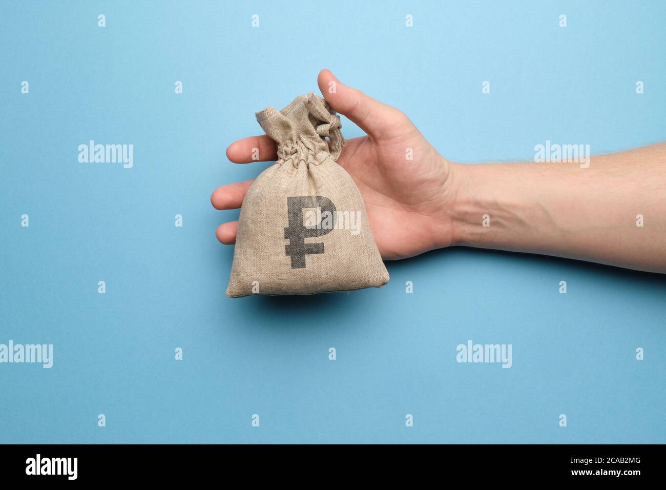 Russian currency symbol ruble on a cloth bag in hand Stock Photo - Alamy