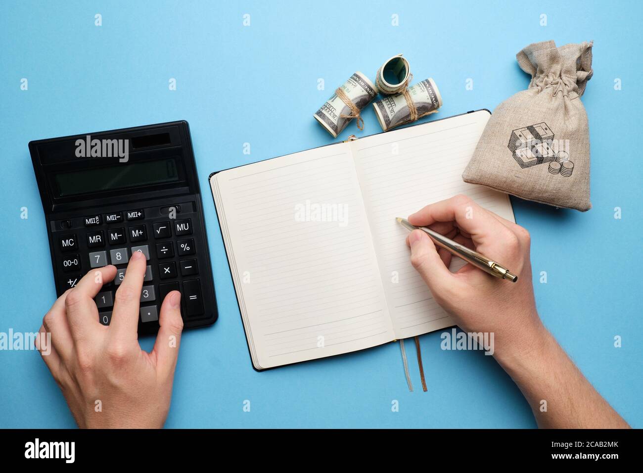 Expenses and income planning concept with hand and diary Stock Photo ...