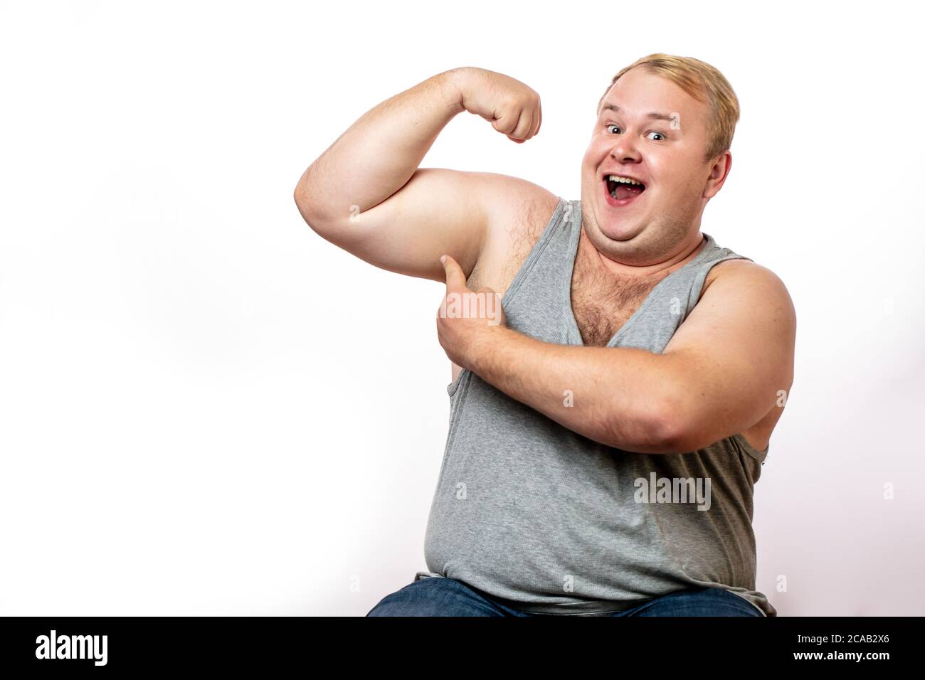 Funny overweight fatso flexing his muscle with self -sure and confident ...