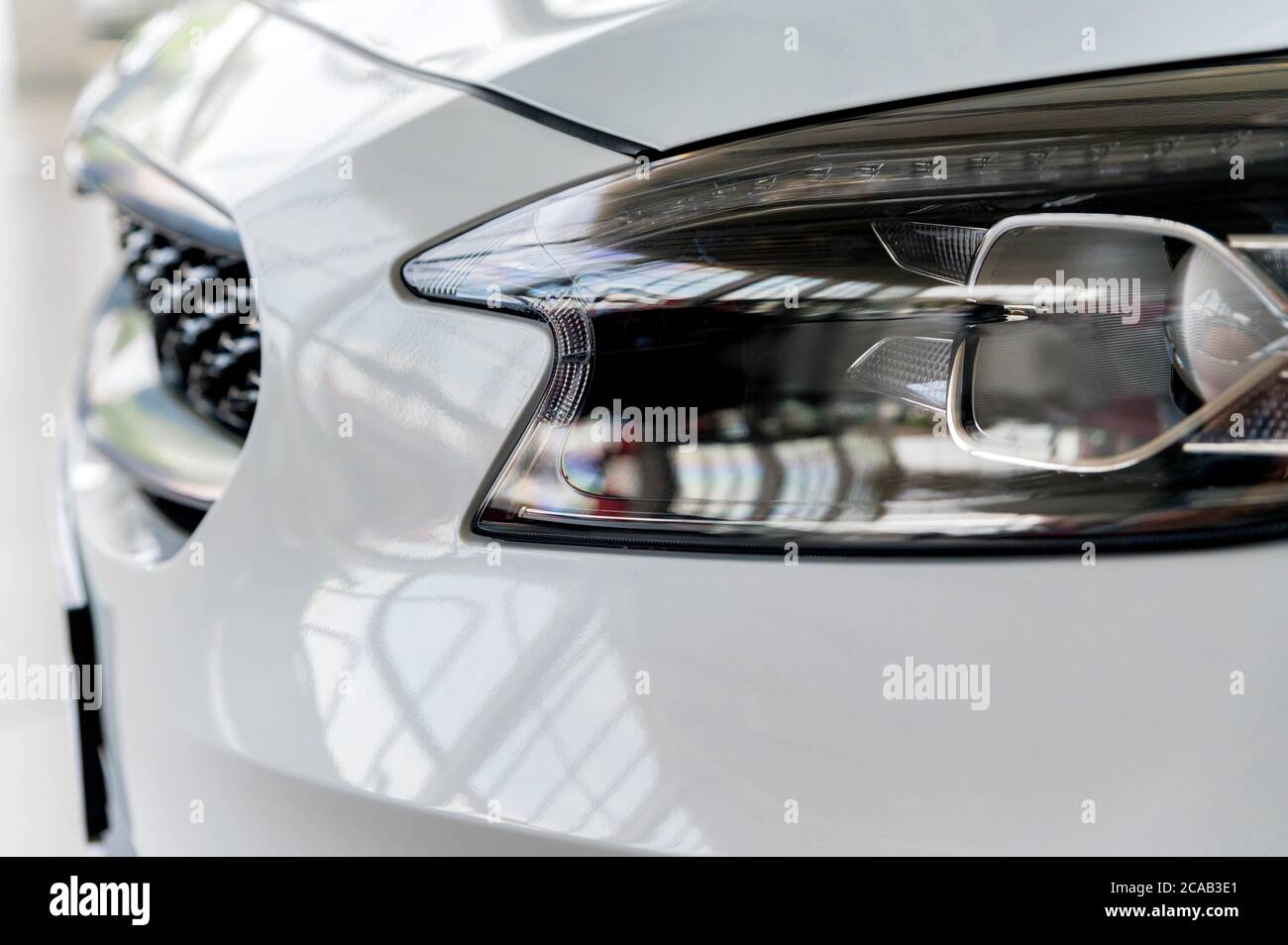 Close-up image of headlights of white modern car Stock Photo - Alamy