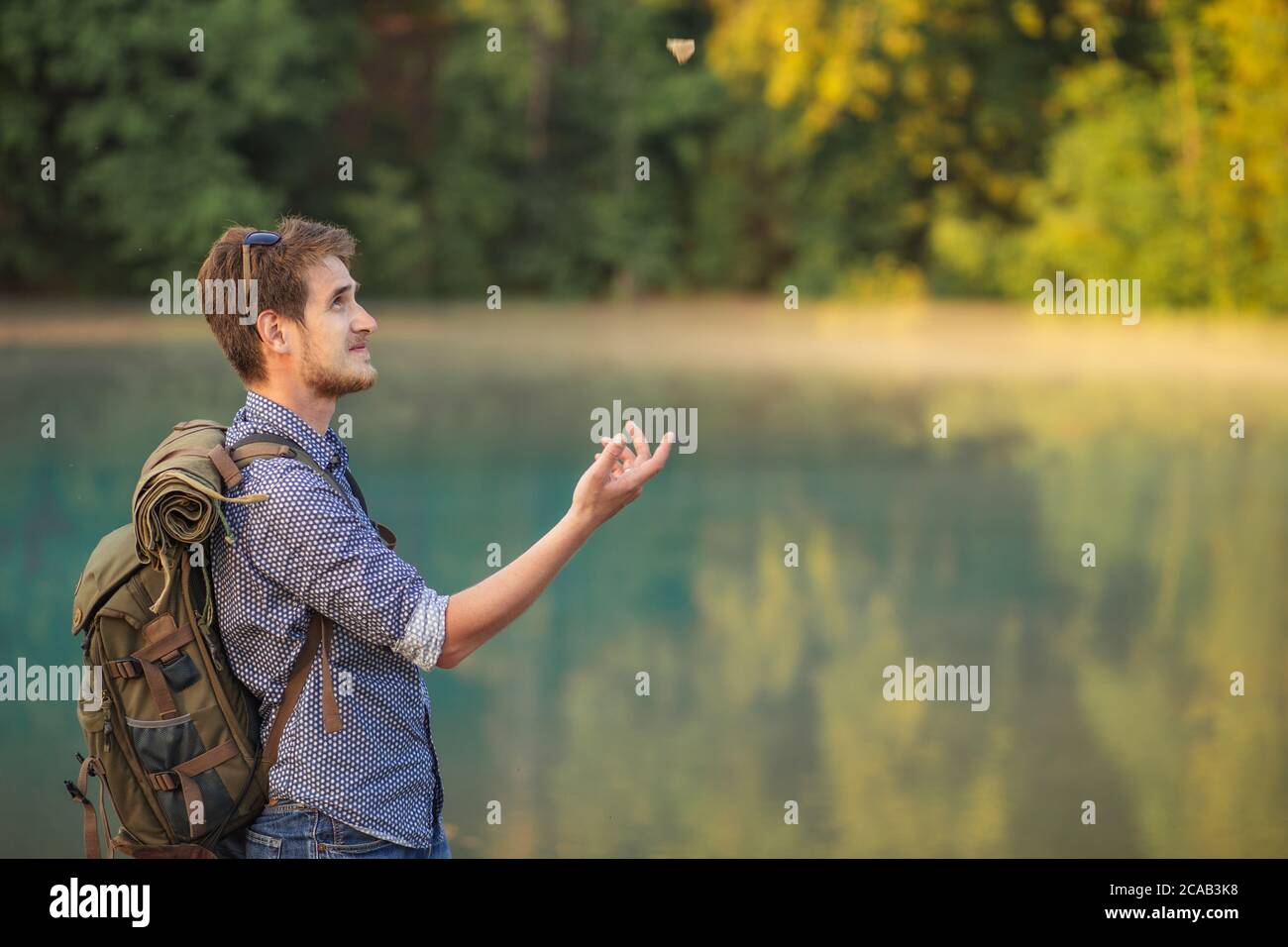 young handsome man is throwing the stone up. close up side view photo ...
