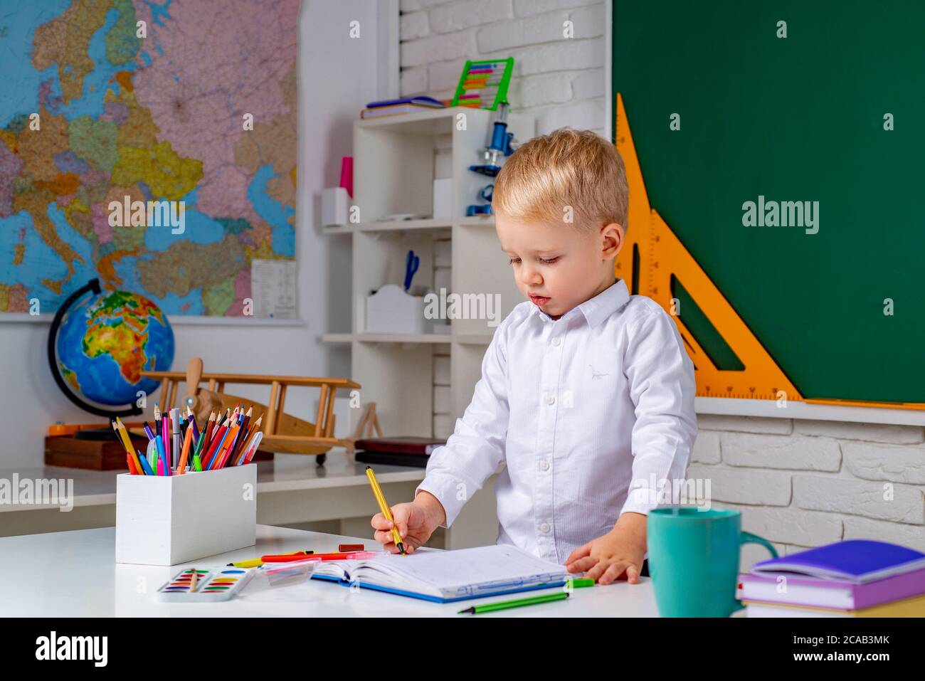 Little ready to study. Little children at school lesson. Child home ...