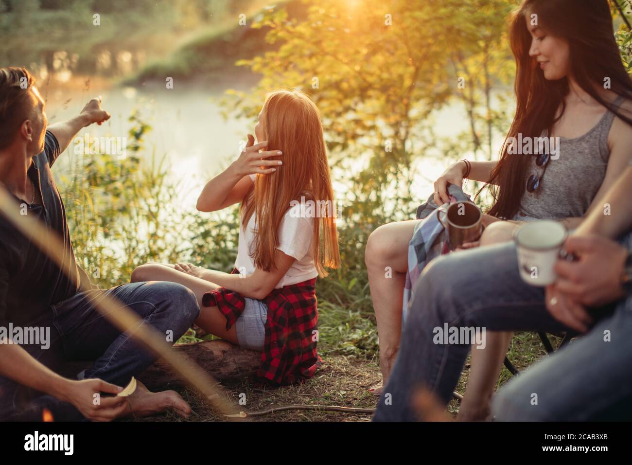 romantic friends are meeting sunrise while camping Stock Photo - Alamy