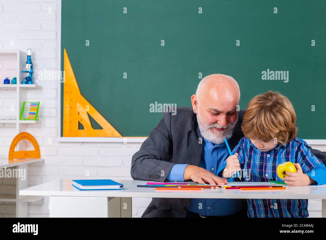 Pupil in class draw with teacher. Educational process Stock Photo - Alamy