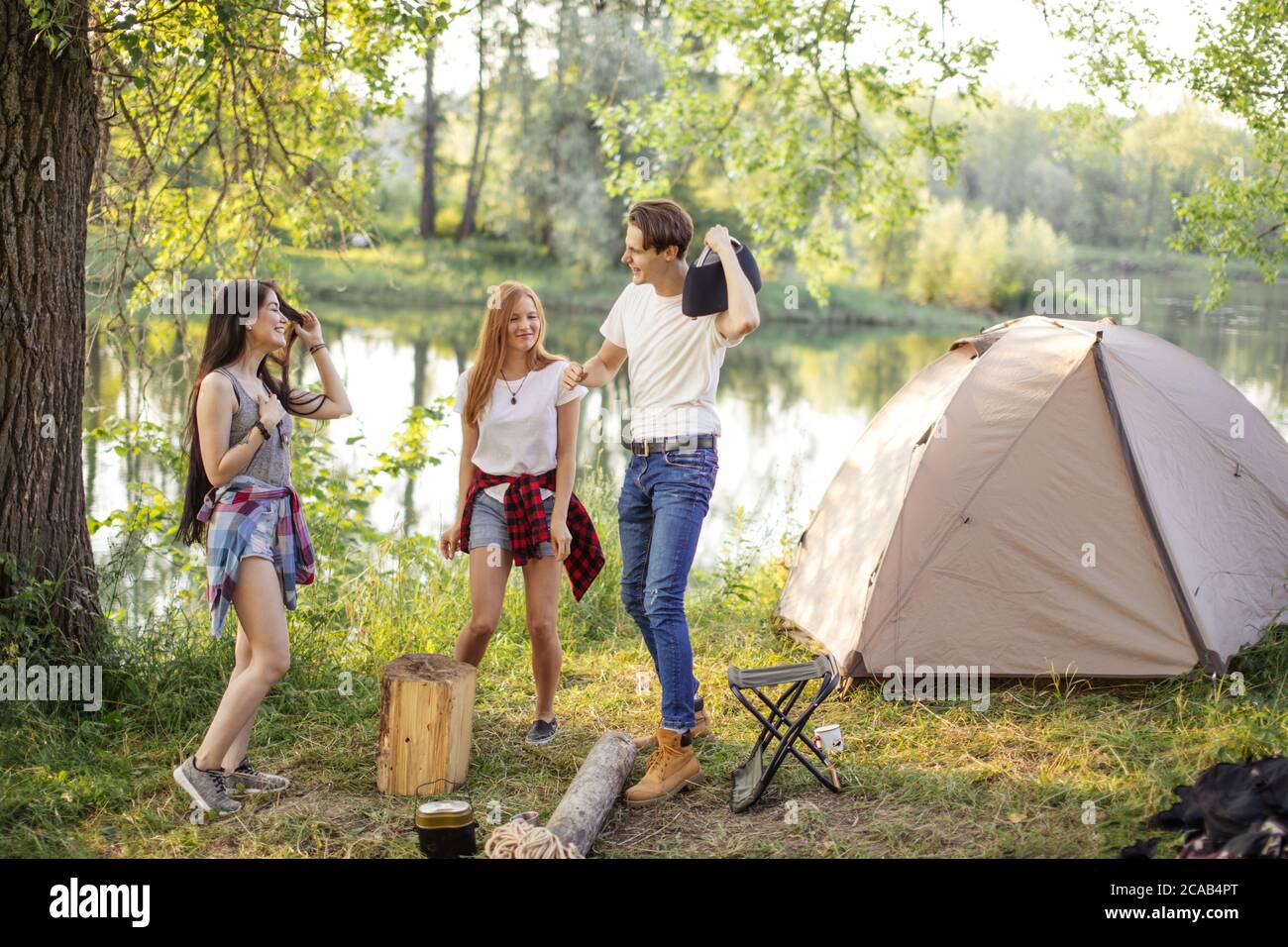 young active tourists are having party at campsite. free time ...