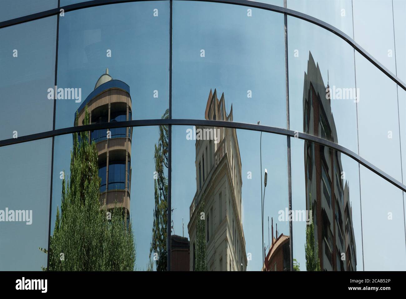Buildings reflected in window Stock Photo - Alamy