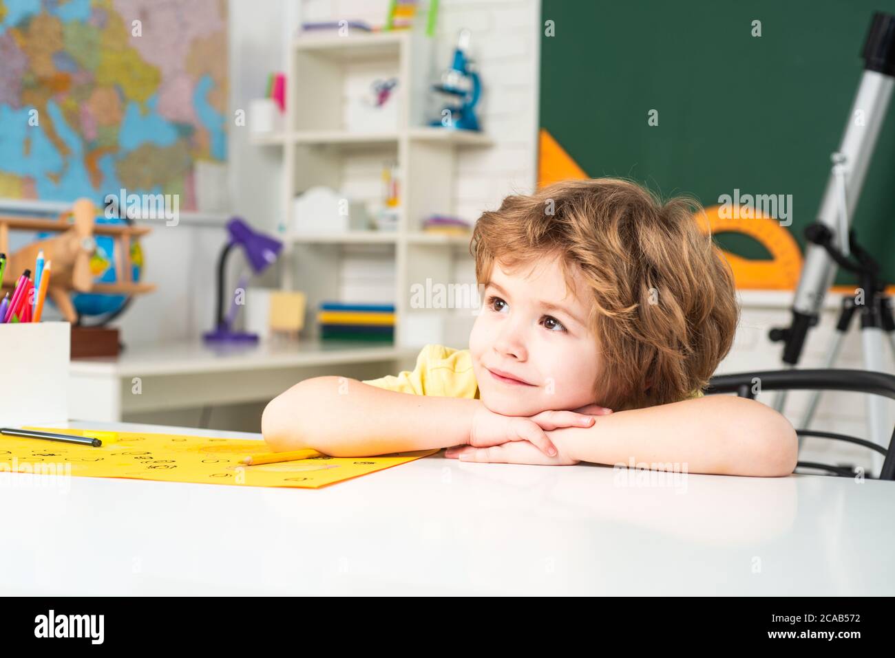 Educational process, cute child boy in classroom. Happy cute ...