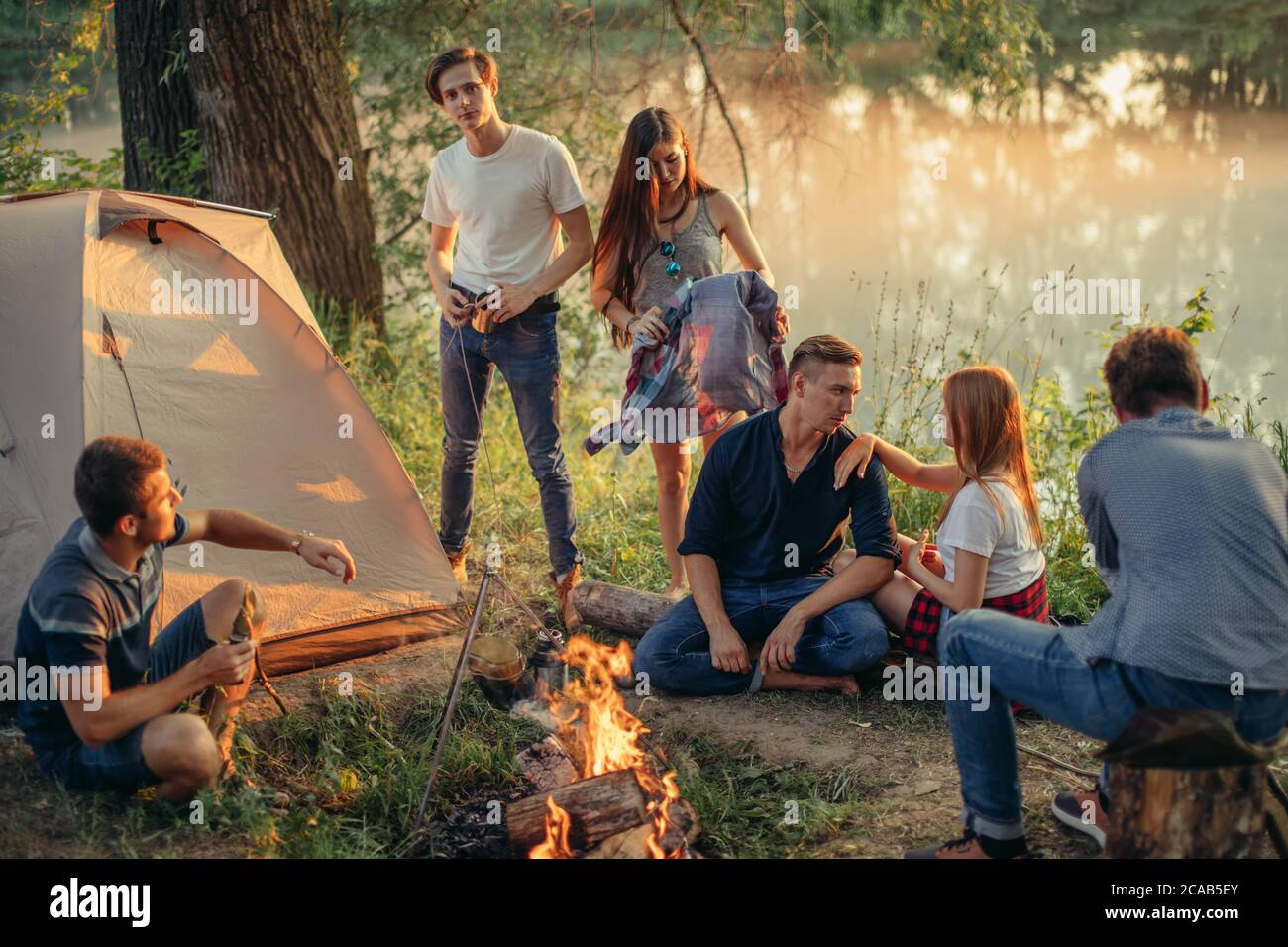 young handsome blond guy is taking offence at girlfriend while resting ...