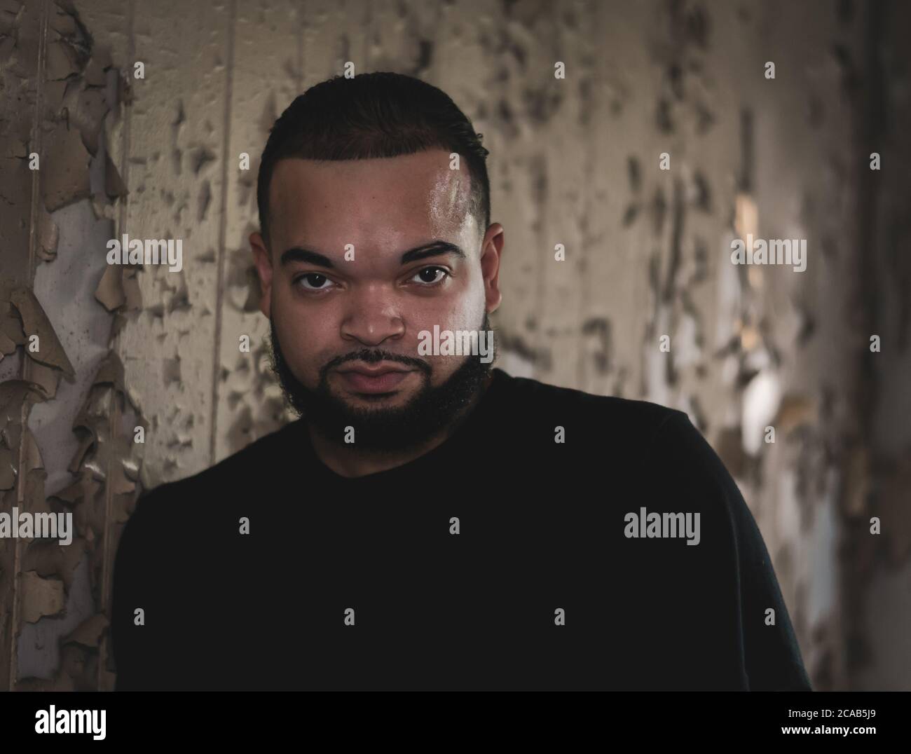Portrait of African American/black man in abandoned house looking at ...