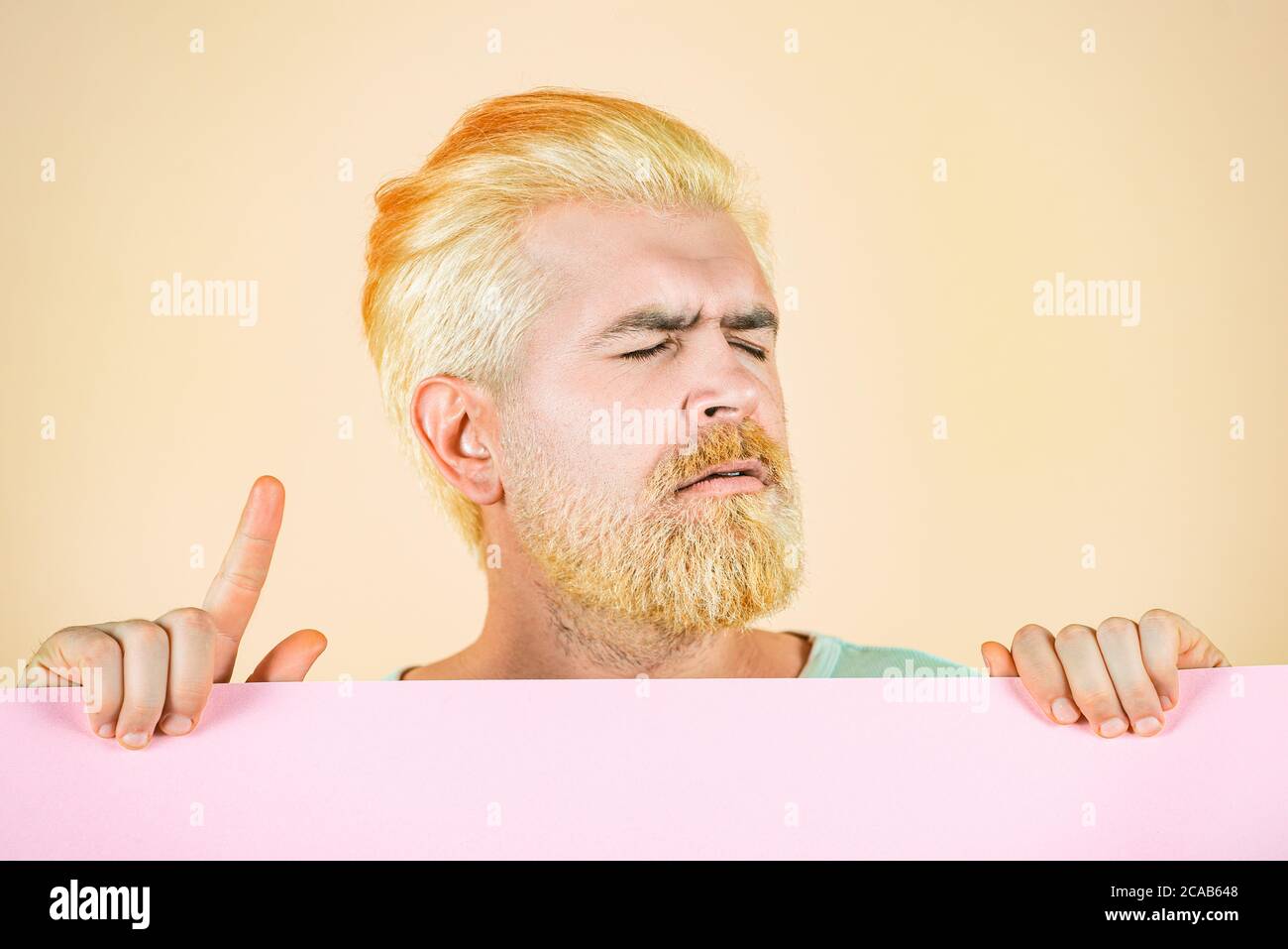 Man holding empty blank board. Caucasian blond male model posing in ...