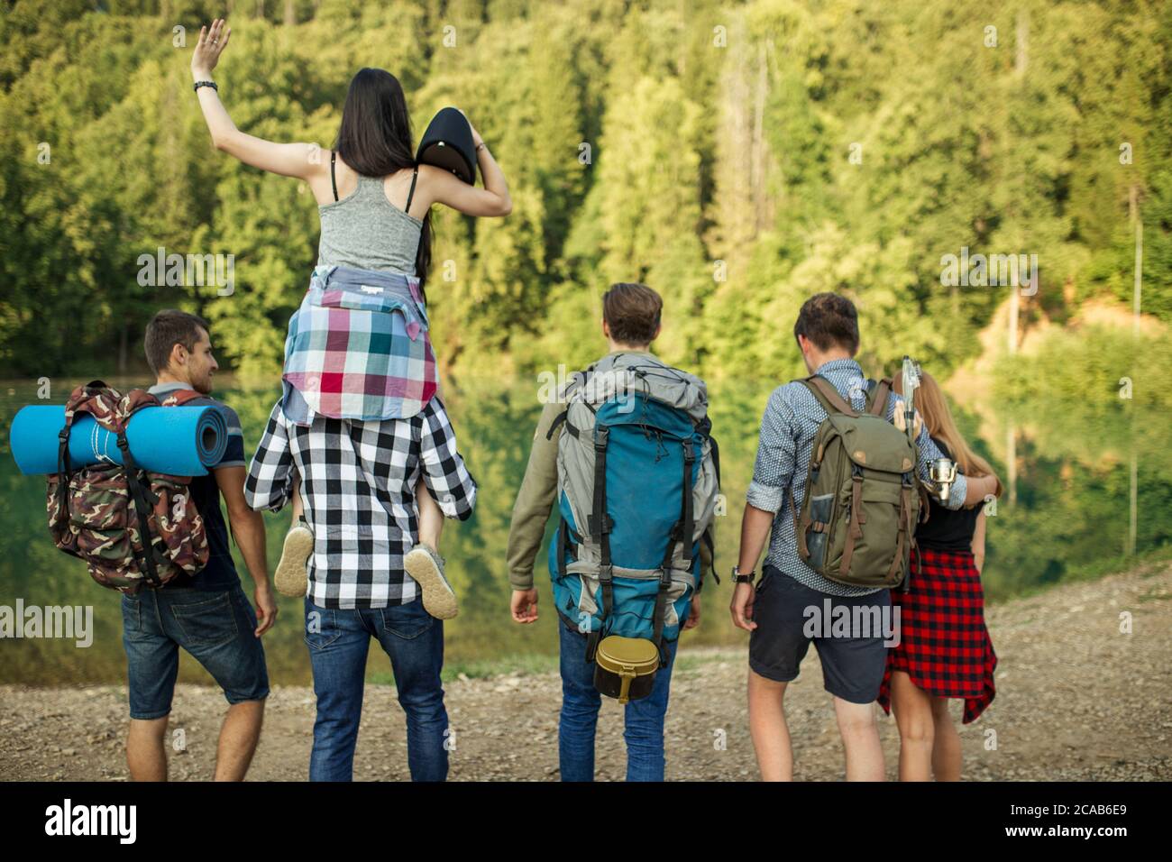 funny girl is hanging out with her adventurous friends. back view photo ...