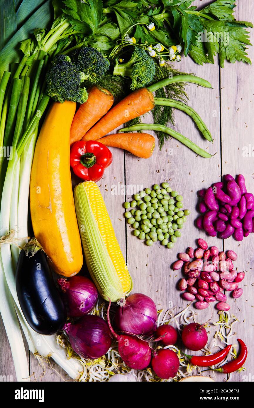 Vertical overhead shot of colorful different vegetables and beans on a ...