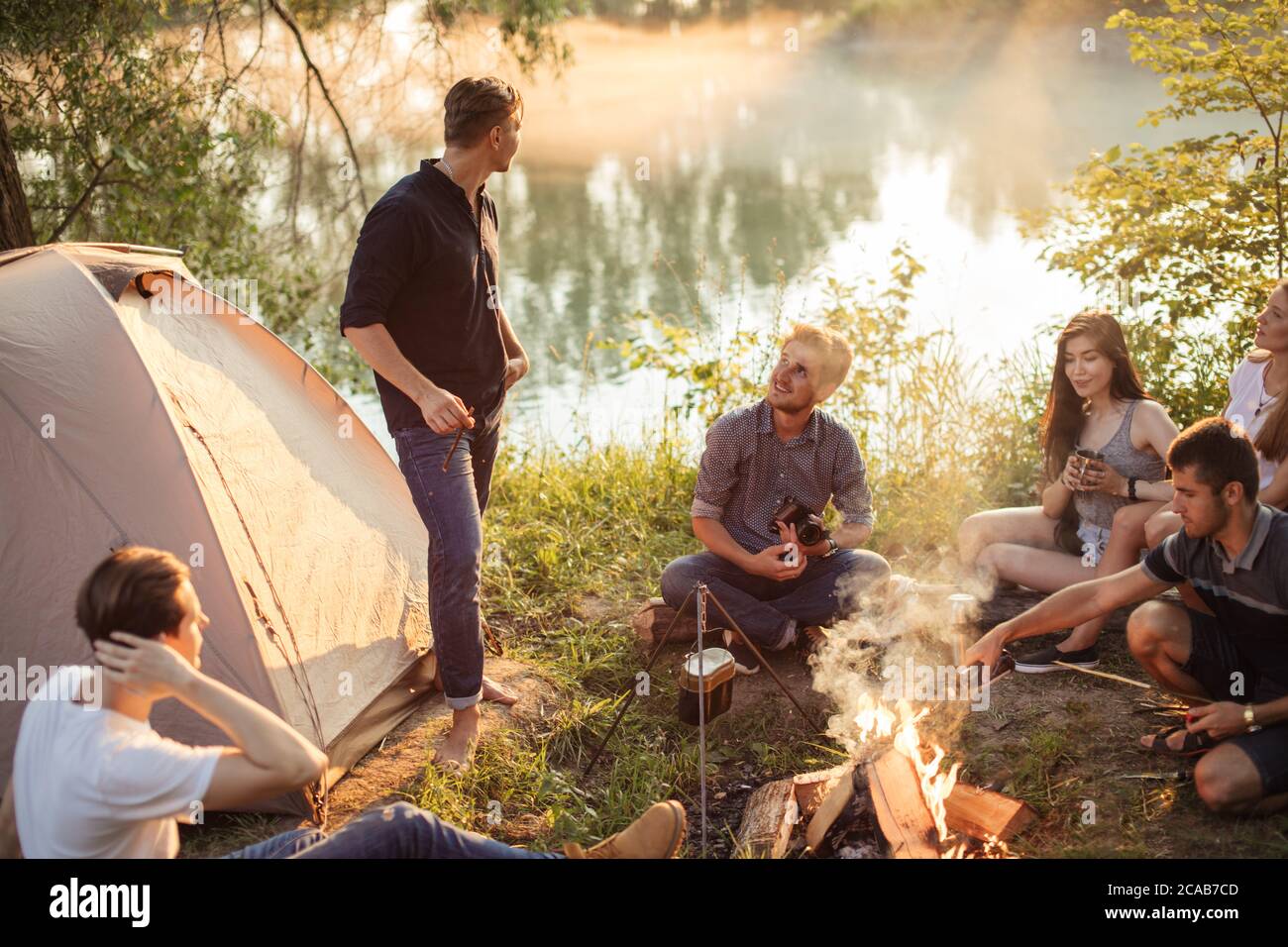 evening friends gathering at camp. friendly chat in nature Stock Photo ...