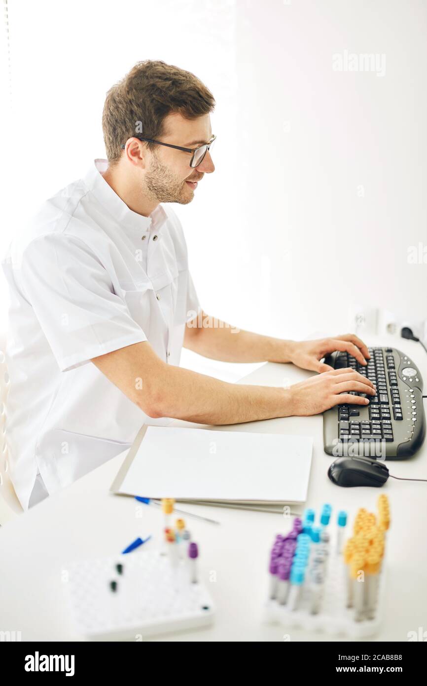 young intern working on the computer in the hospital. internship ...