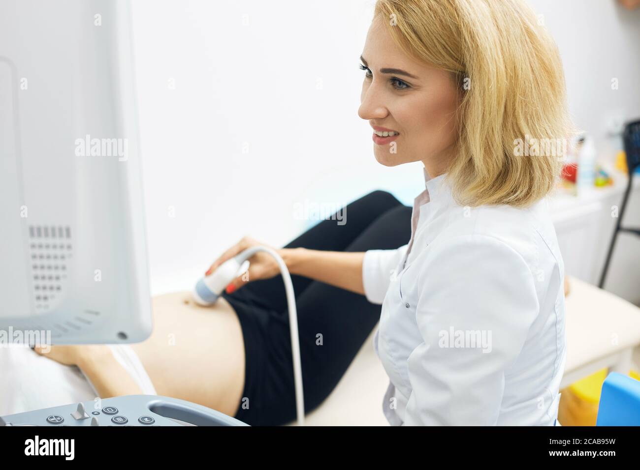 positive medical worker using sonographic instrument. close up side ...