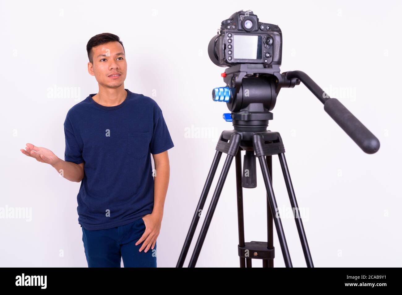 Portrait of young Asian man with camera Stock Photo - Alamy