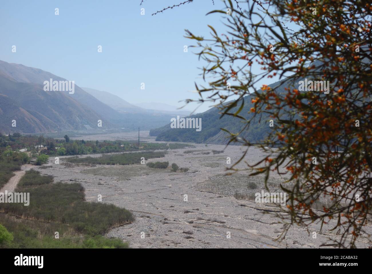 Wide river with a very strong stream surrounded by hills Stock Photo ...