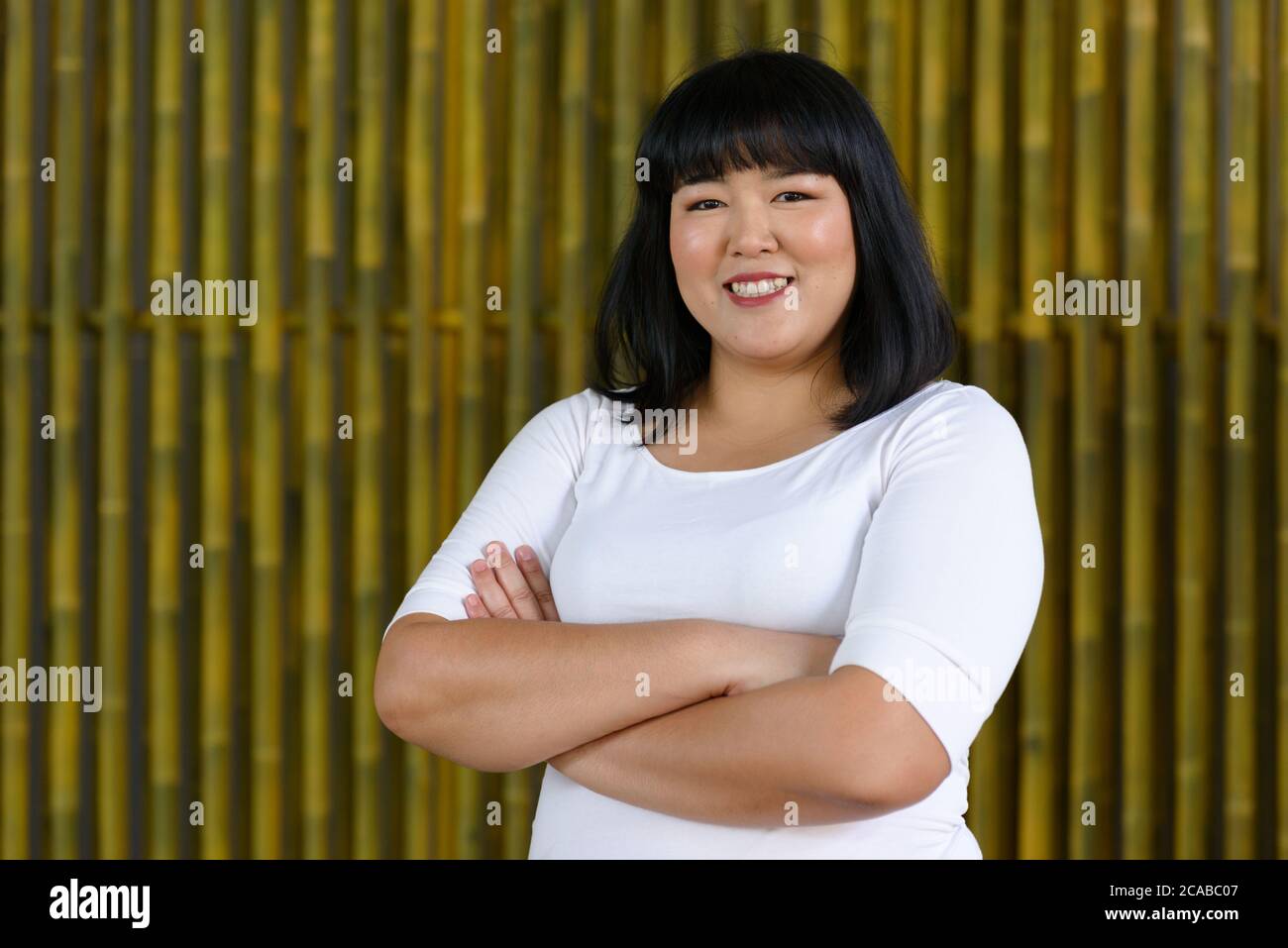Happy young beautiful overweight Asian woman outdoors Stock Photo - Alamy
