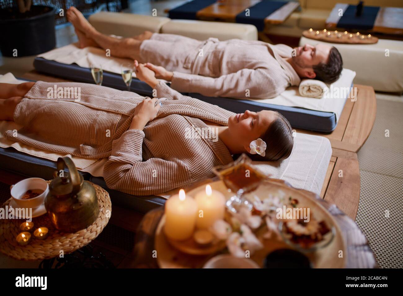 young man and woman, couple in love relaxing together at spa salon ...