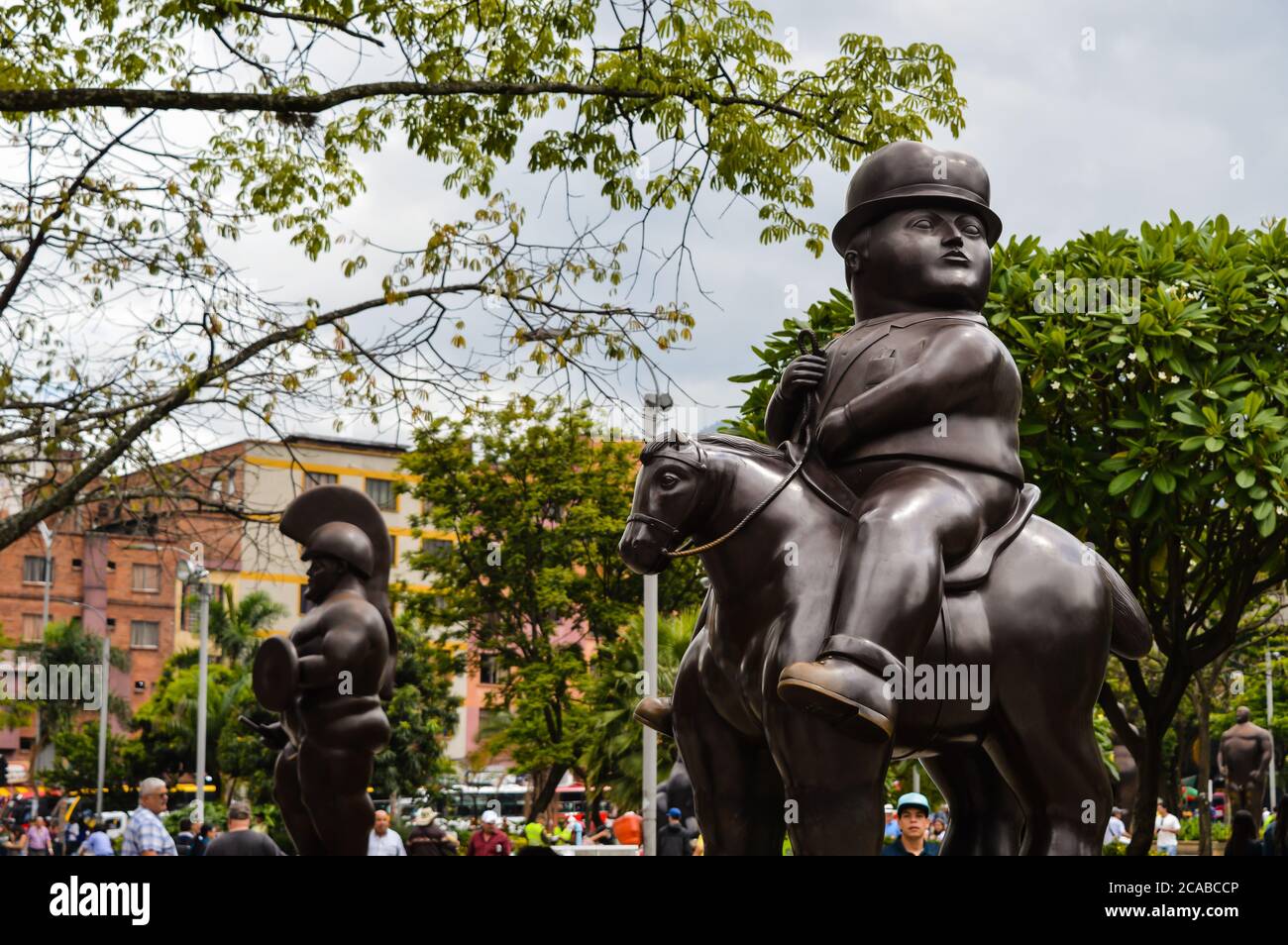 Big black metal statues of soldiers in a city park with trees Stock ...