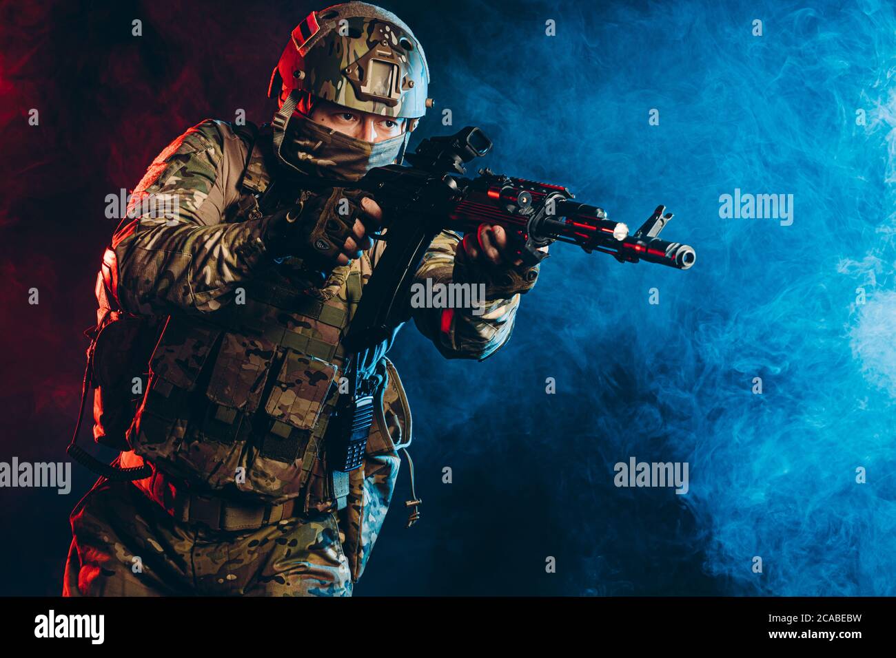 courageous soldier man in green military wear holding gun, rifle in ...