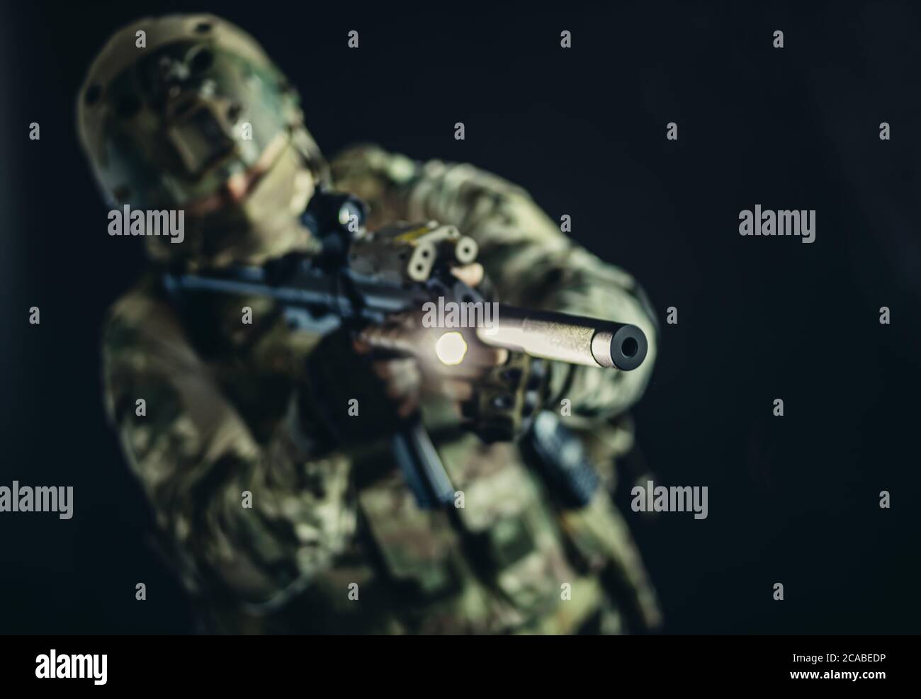 attack during war. man carrying out military service aiming his weapon ...