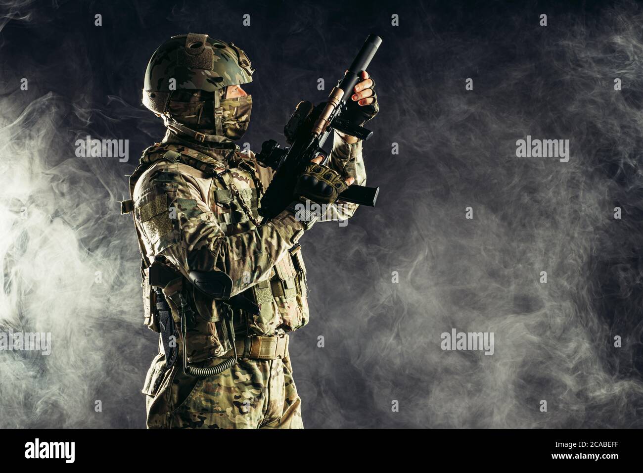 attack during war. man carrying out military service aiming his weapon ...