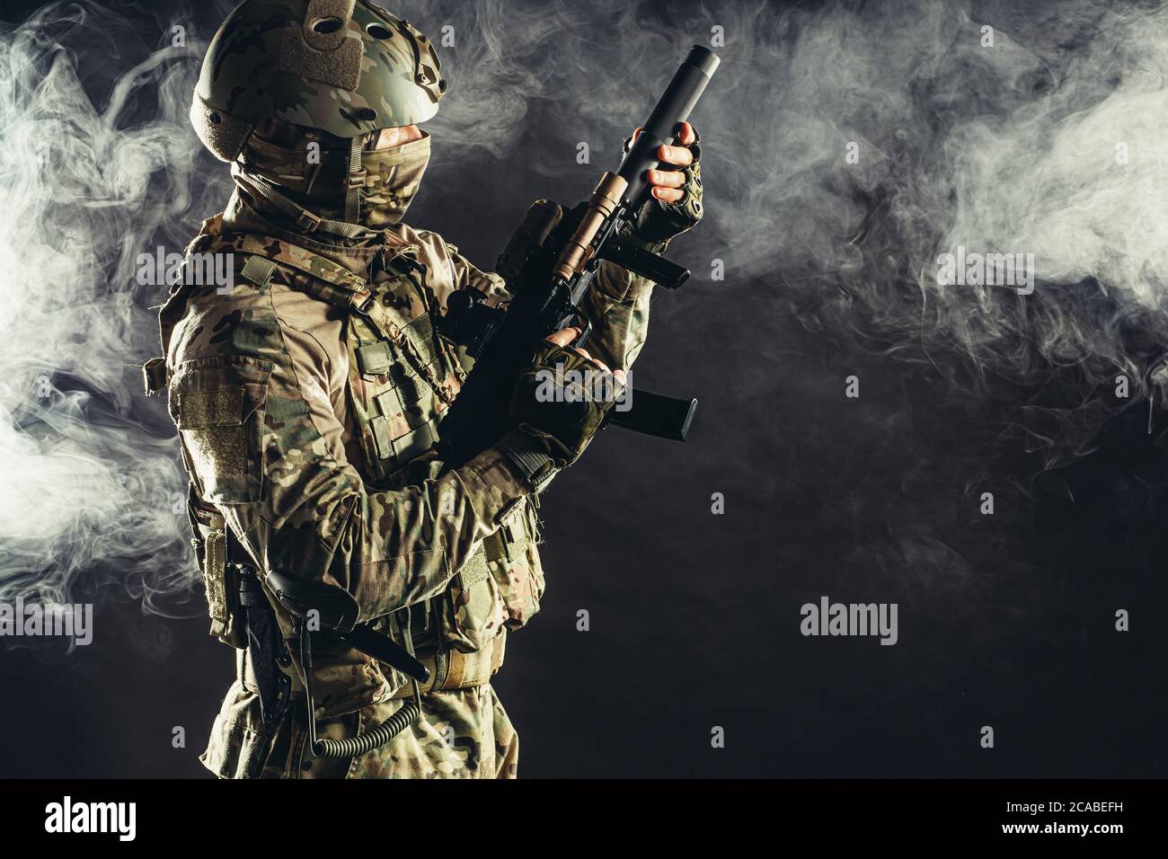 young man from military forces in green military wear try to shoot on ...