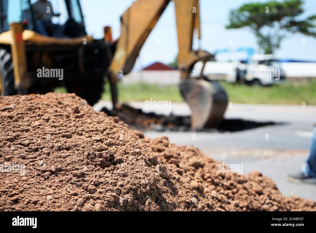 Heavy equipment is digging to repair the damaged road (blurred picture ...