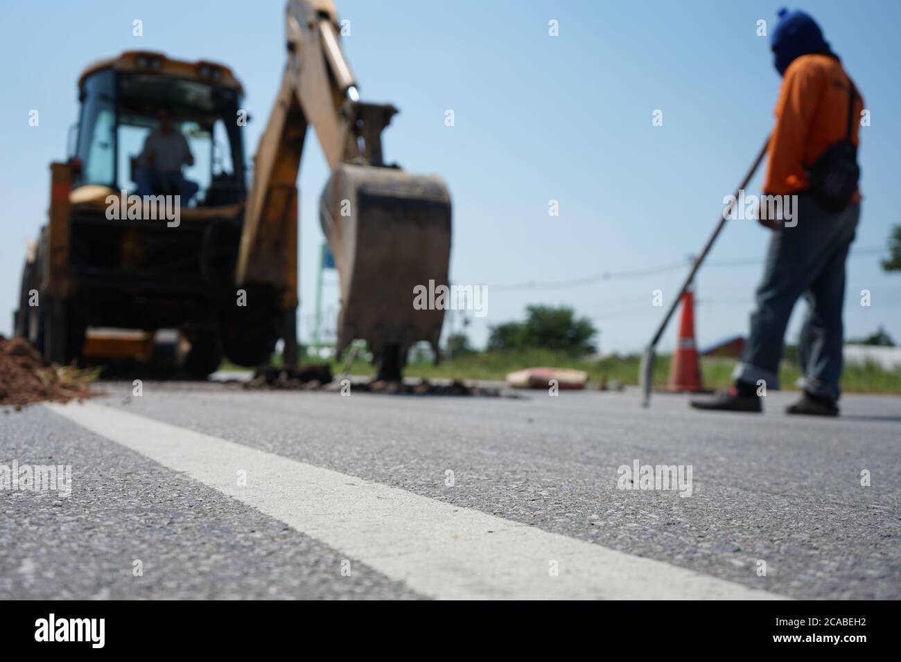 Heavy equipment is digging to repair the damaged road (blurred picture ...