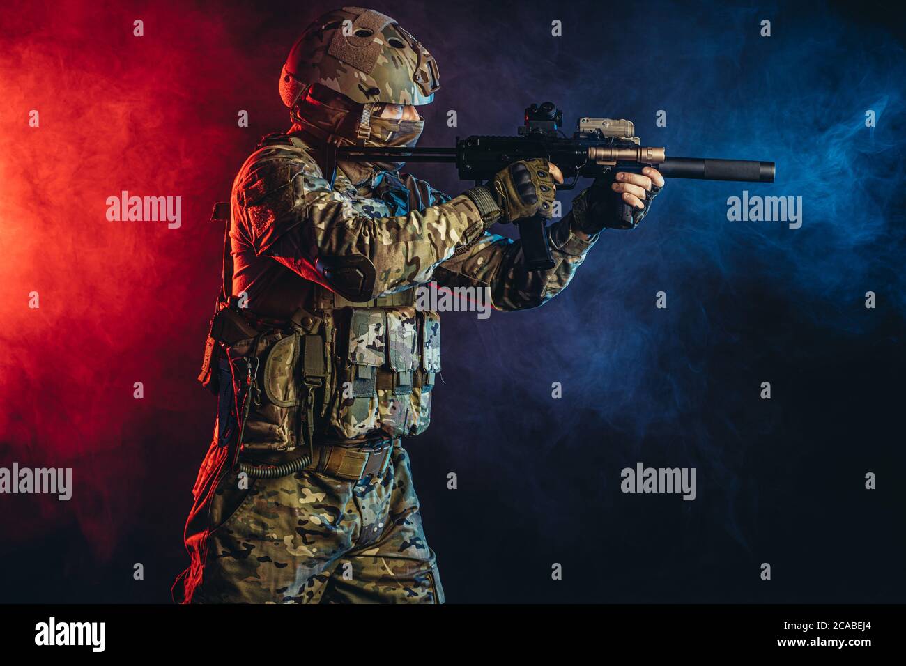 courageous soldier man in green military wear holding gun, rifle in ...