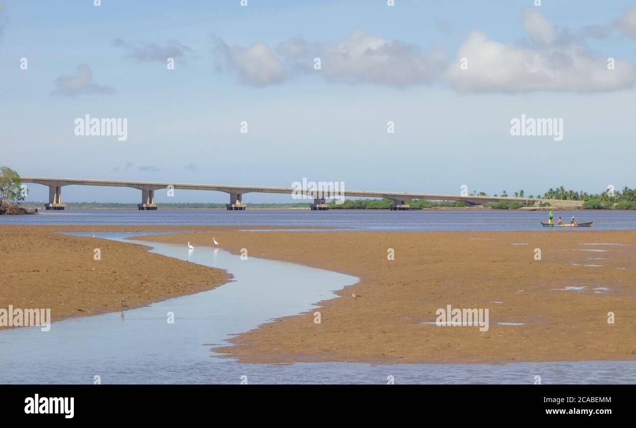 Bridge over a river and a boat floating on the water Stock Photo - Alamy