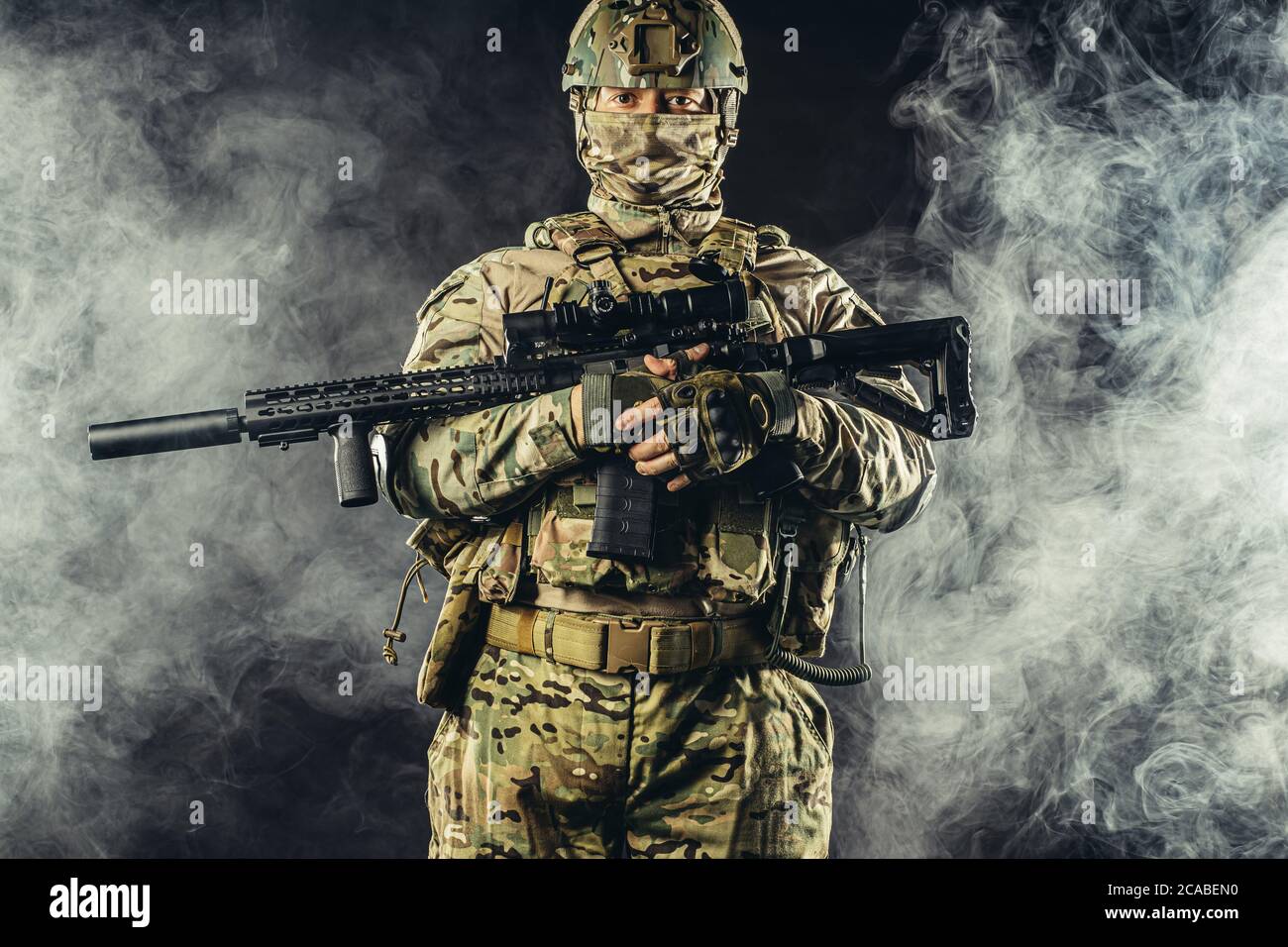 attack during war. man carrying out military service aiming his weapon ...