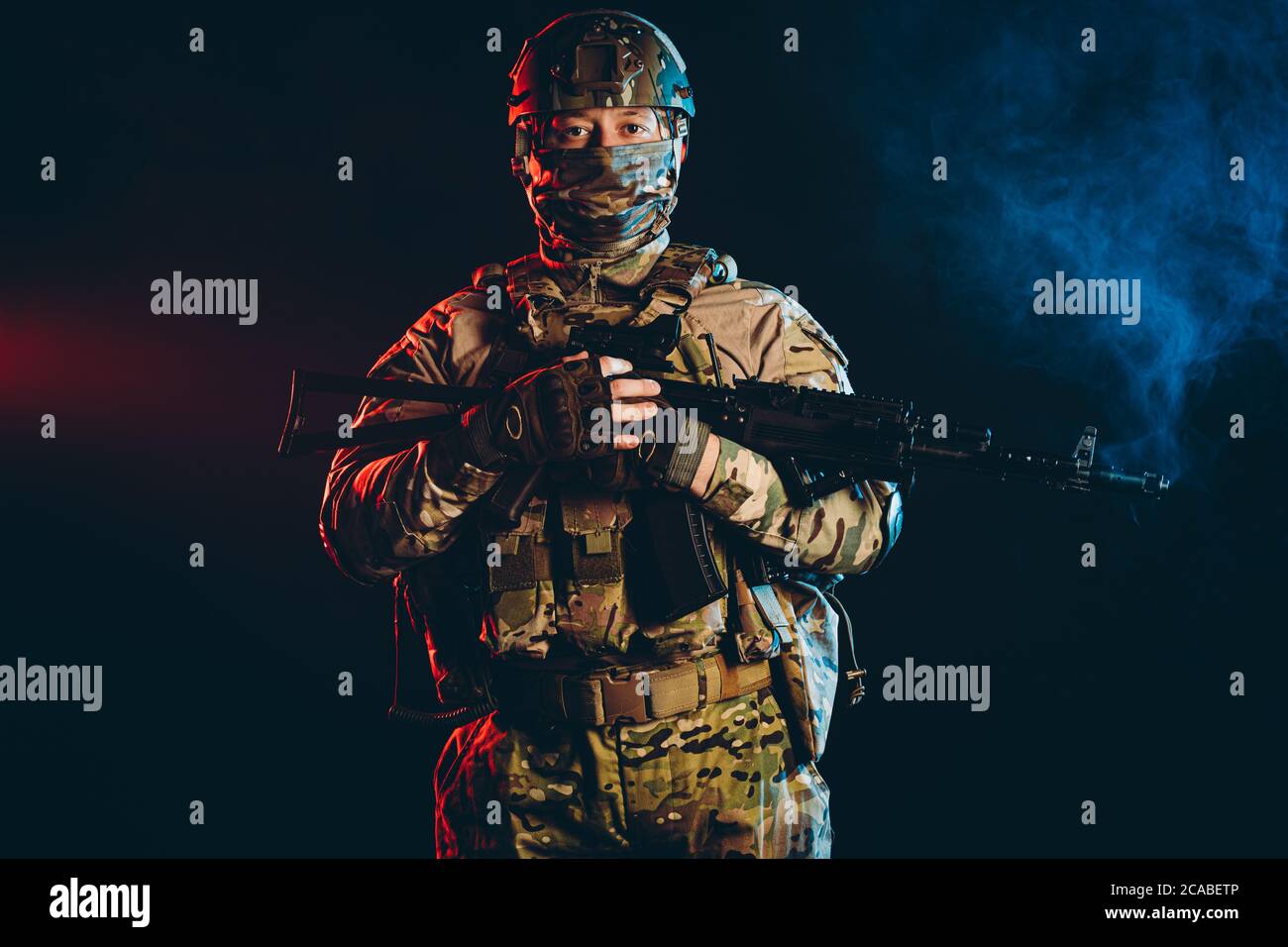 portrait of military man with gun isolated over smoky background ...
