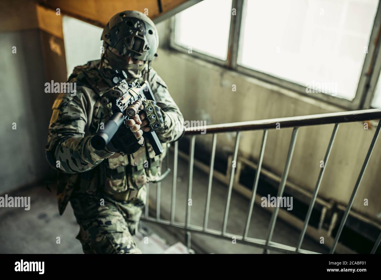 brave and strong soldier in military uniform holding rifle in hands ...